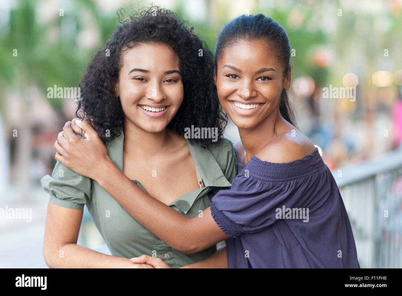 Black women hugging on balcony Stock Photo - Alamy