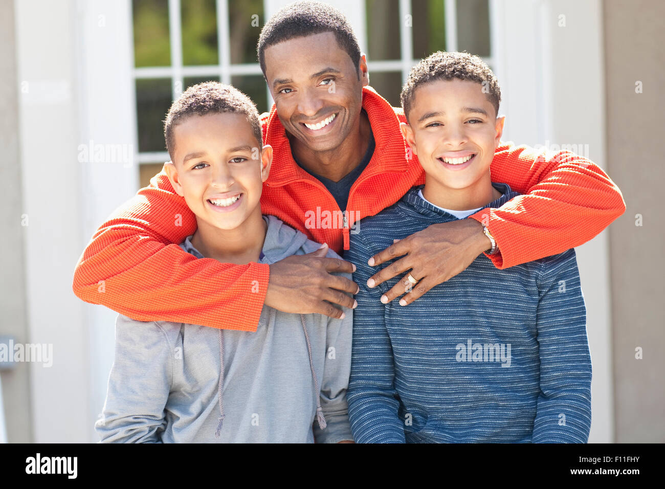 Father hugging sons outdoors Stock Photo - Alamy