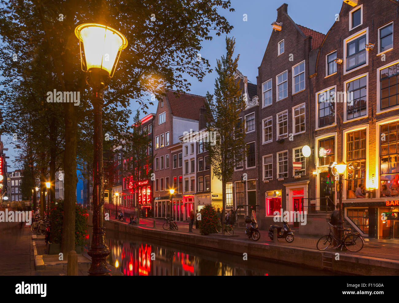 Illuminated streetlights on Amsterdam canal street, Netherland Stock ...