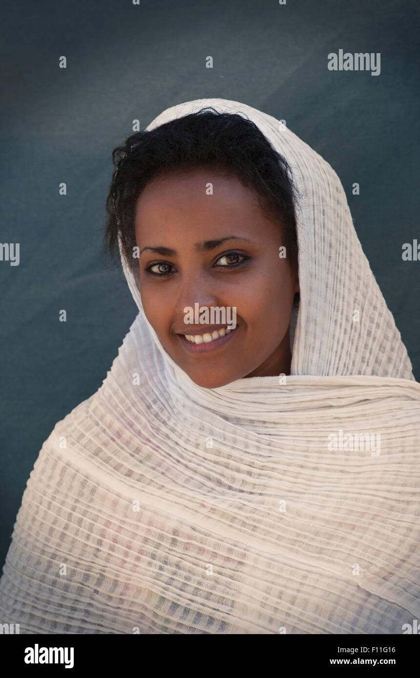 Smiling Black woman wrapped in scarf Stock Photo - Alamy