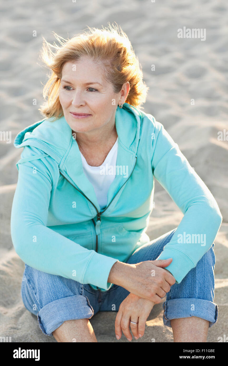 Woman seated on beach hi-res stock photography and images - Alamy