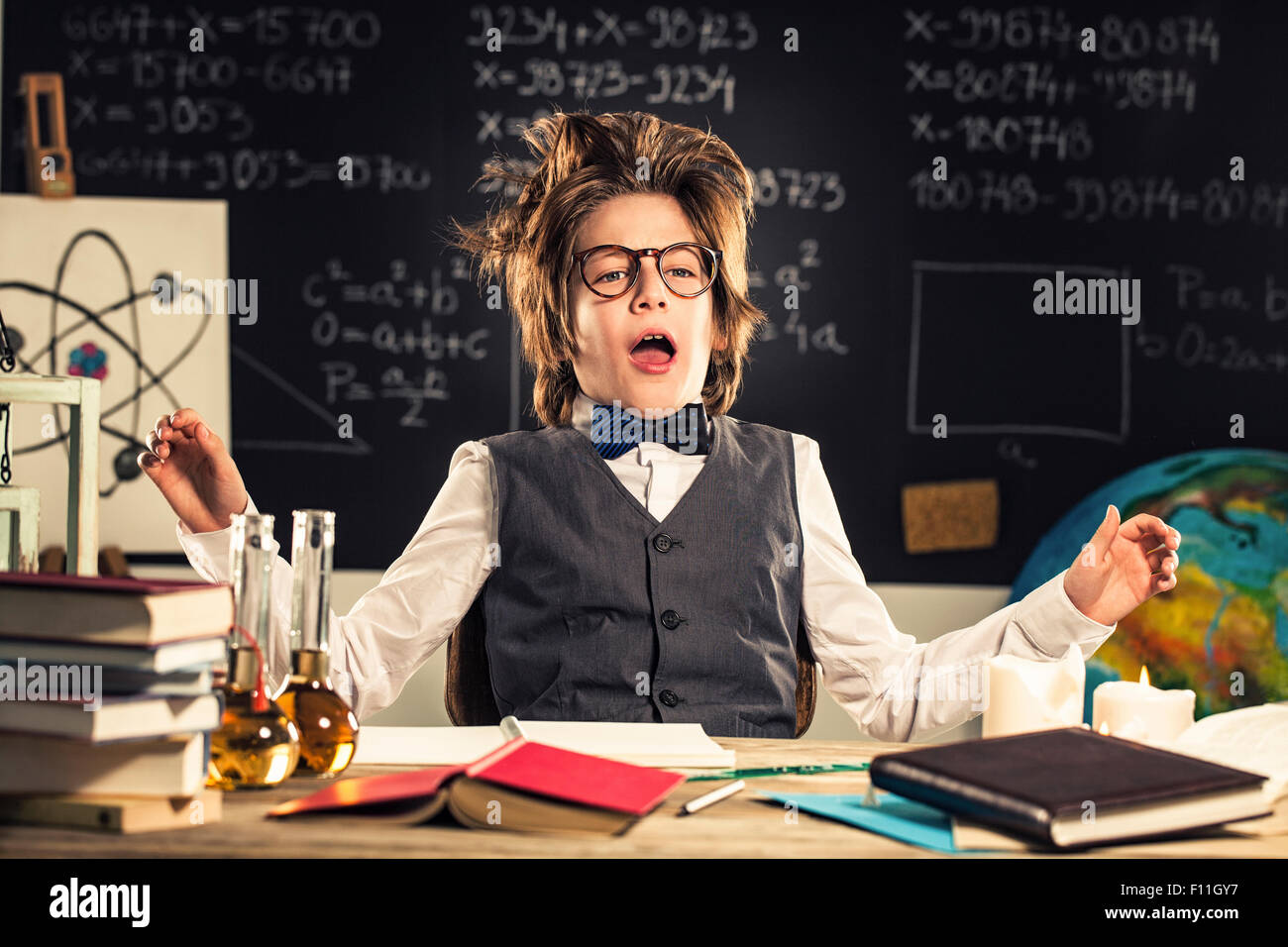 Student talking at desk in classroom Stock Photo - Alamy