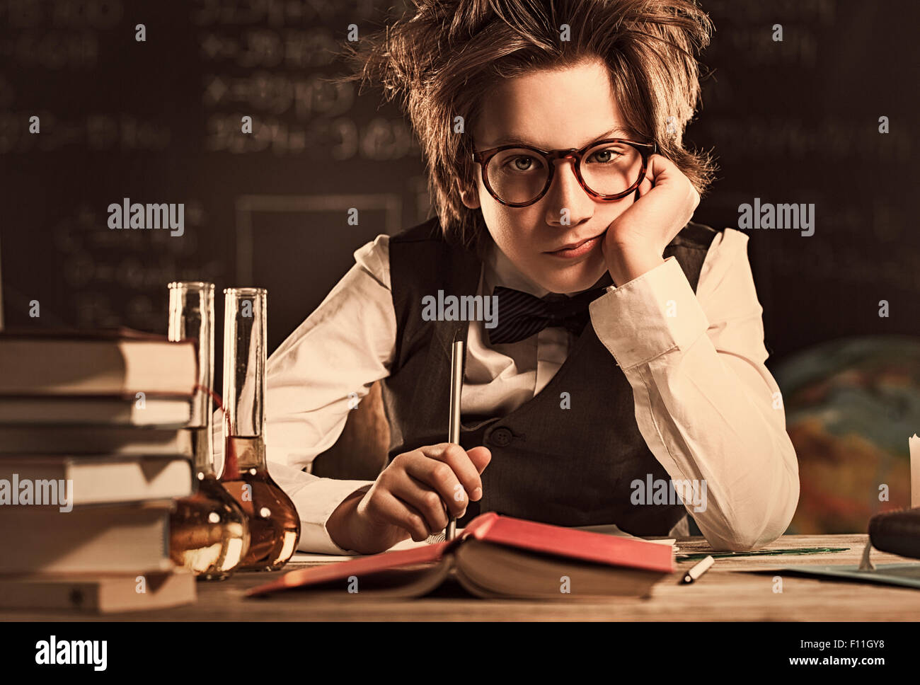 Bored student sitting at desk in classroom Stock Photo - Alamy