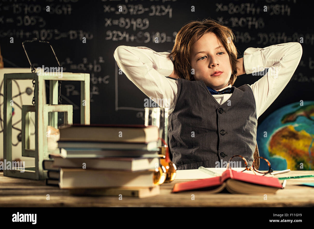 Bored student sitting at desk in classroom Stock Photo - Alamy