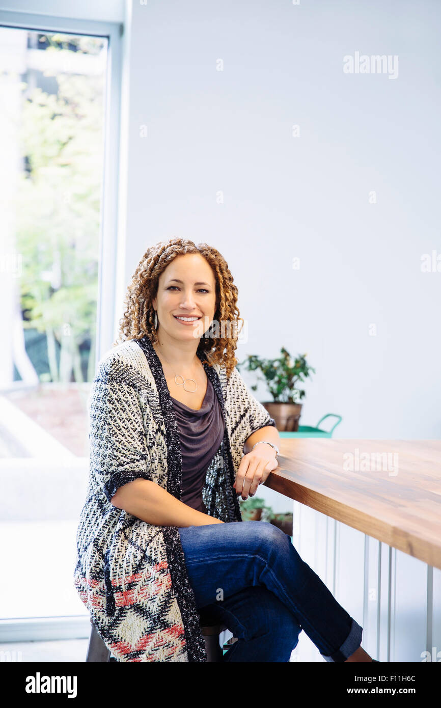 Smiling female sitting counter hi-res stock photography and images - Alamy