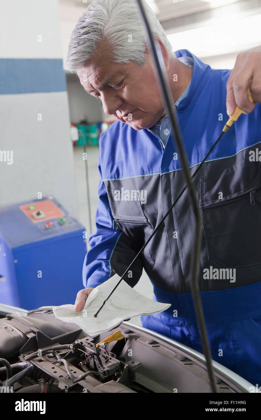 Older Hispanic mechanic repairing car in garage Stock Photo - Alamy