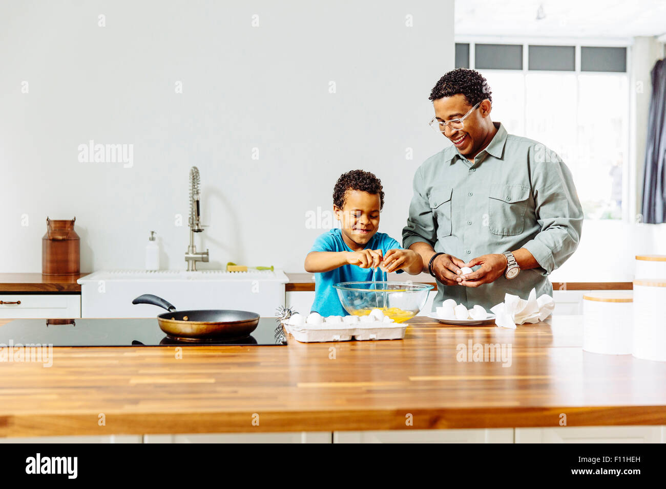 Father and son cooking in kitchen Stock Photo - Alamy
