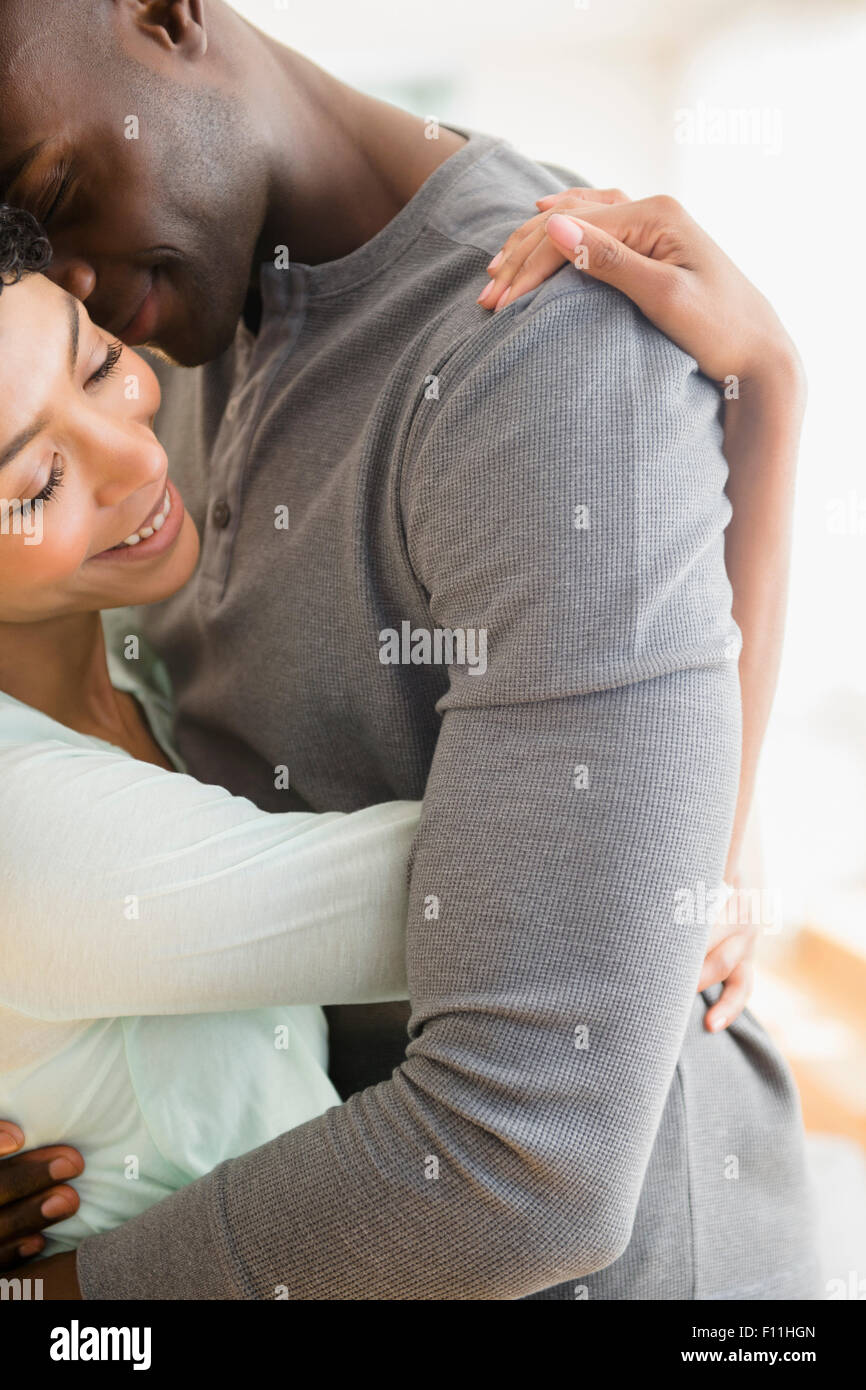 Close up of smiling couple hugging Stock Photo - Alamy