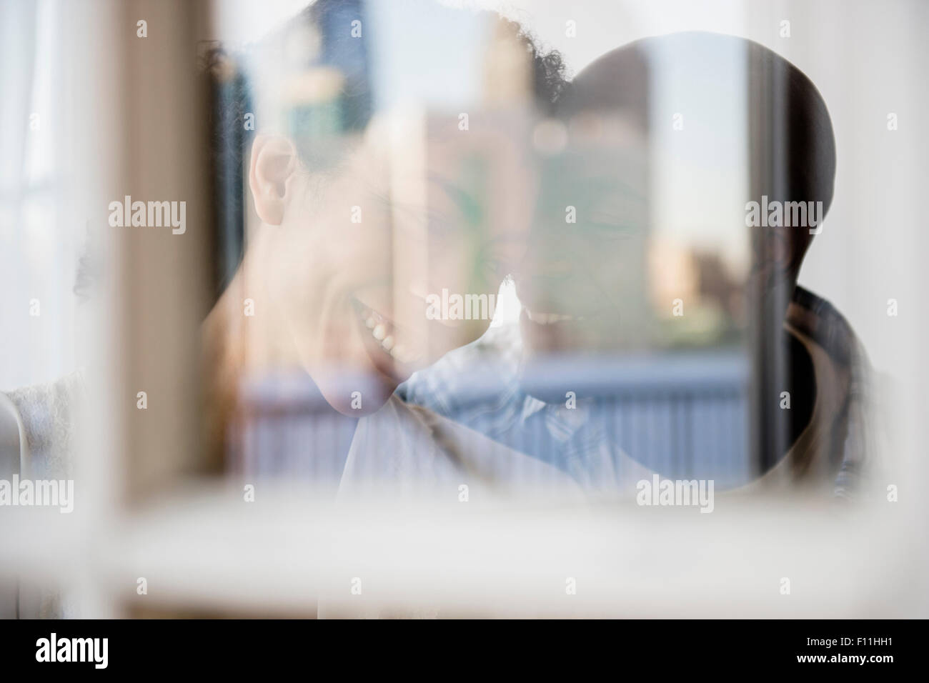 Couple hugging behind window Stock Photo - Alamy