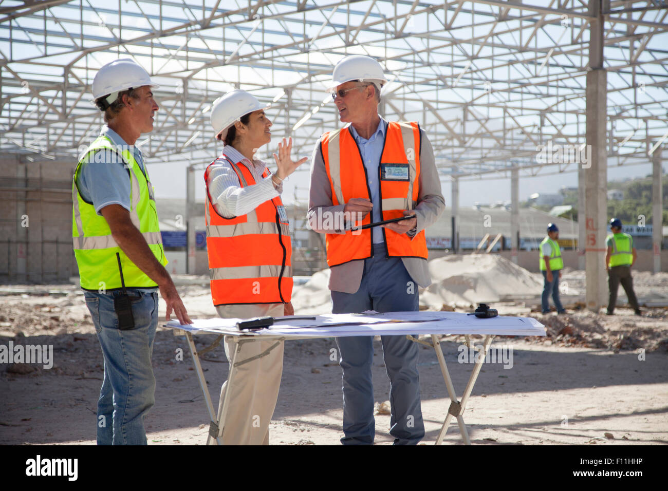 Architects talking at construction site Stock Photo - Alamy