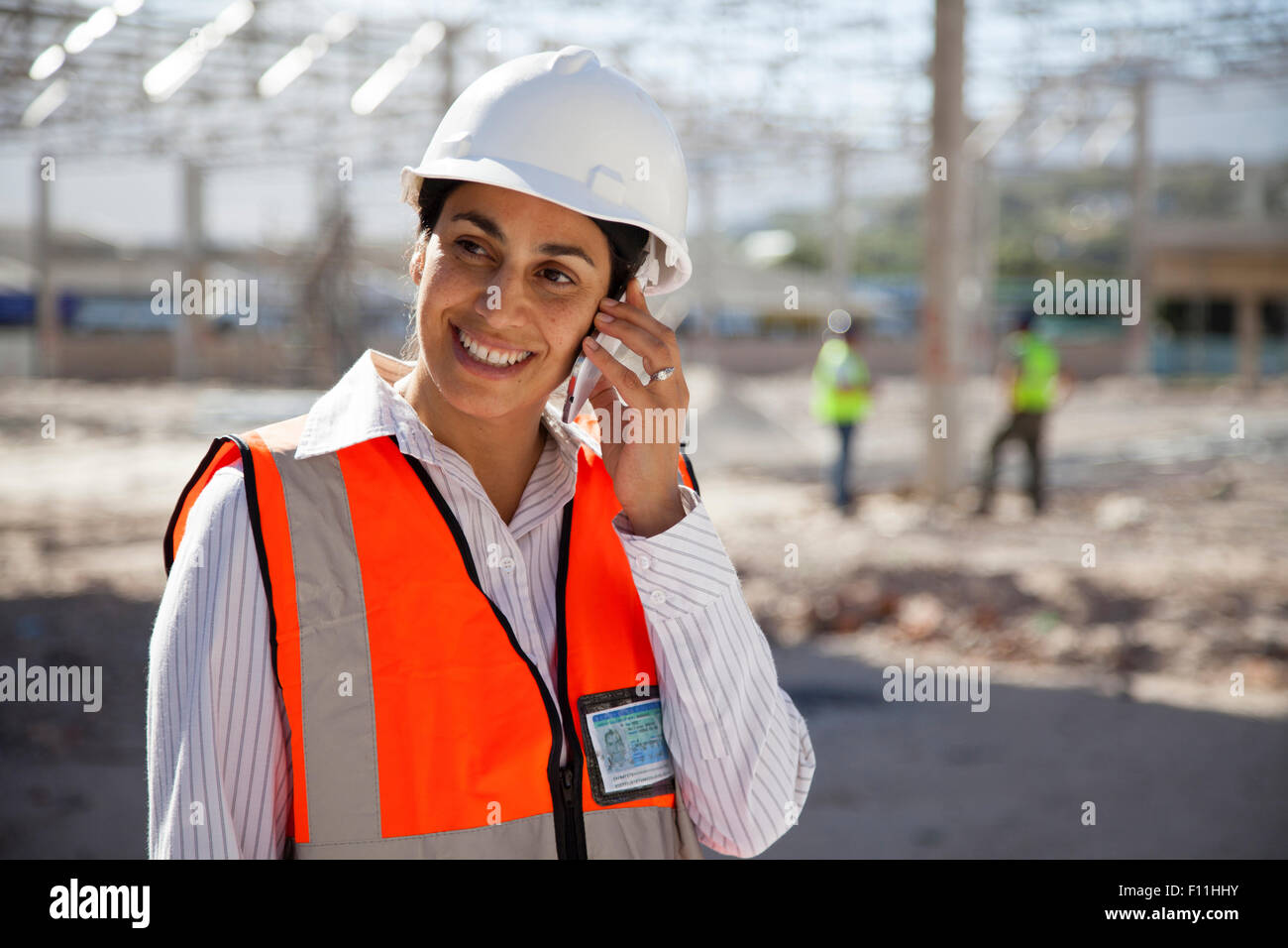 Architect talking on cell phone at construction site Stock Photo - Alamy