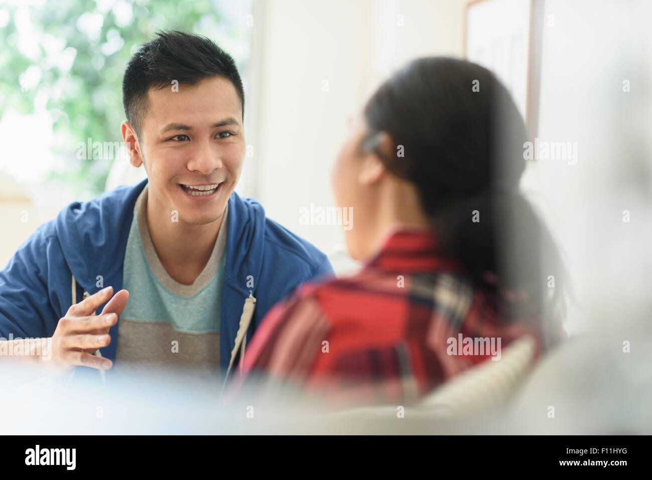 Young couple talking living room hi-res stock photography and images ...