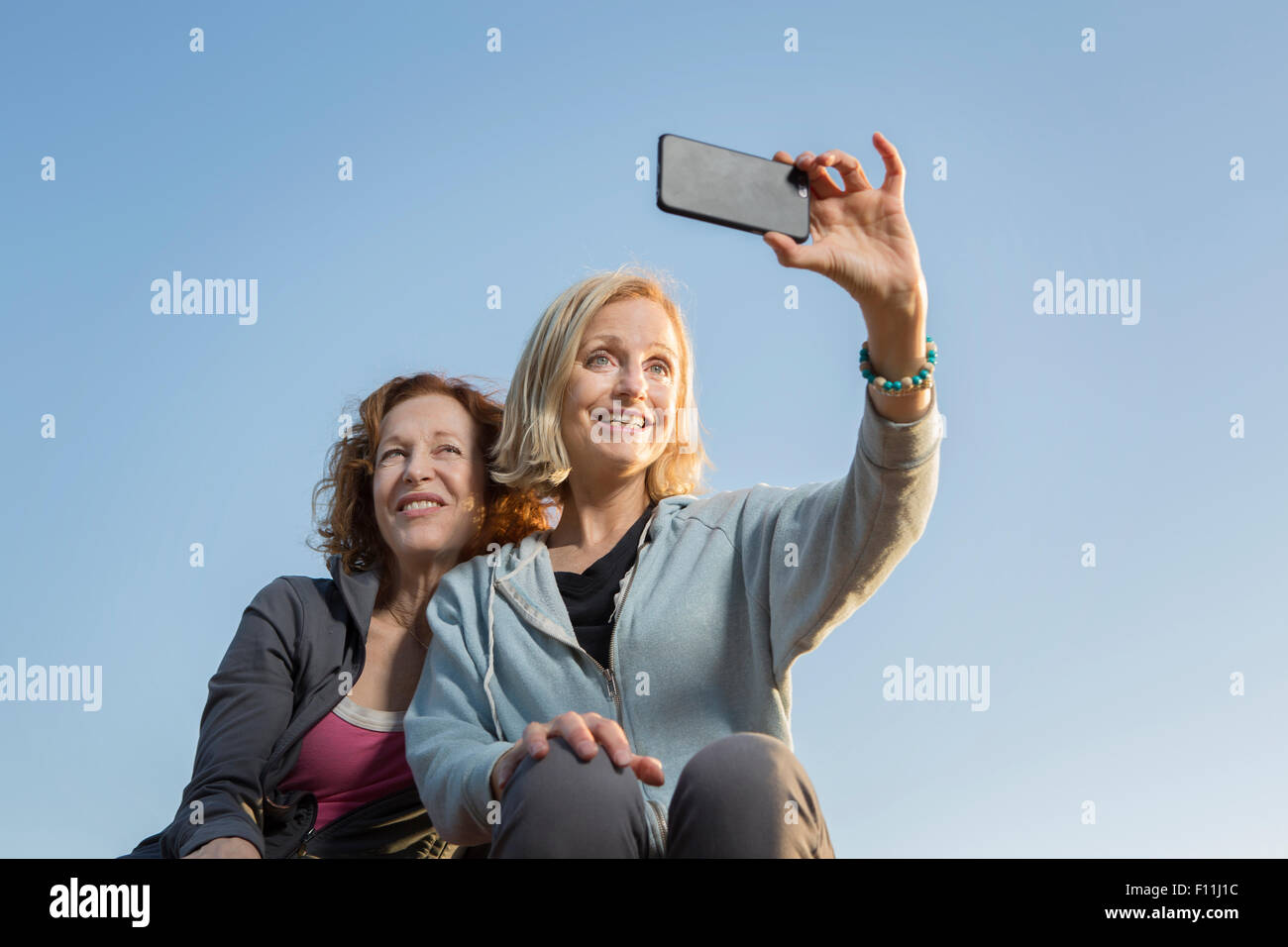 Low angle view of Caucasian women taking selfie Stock Photo - Alamy