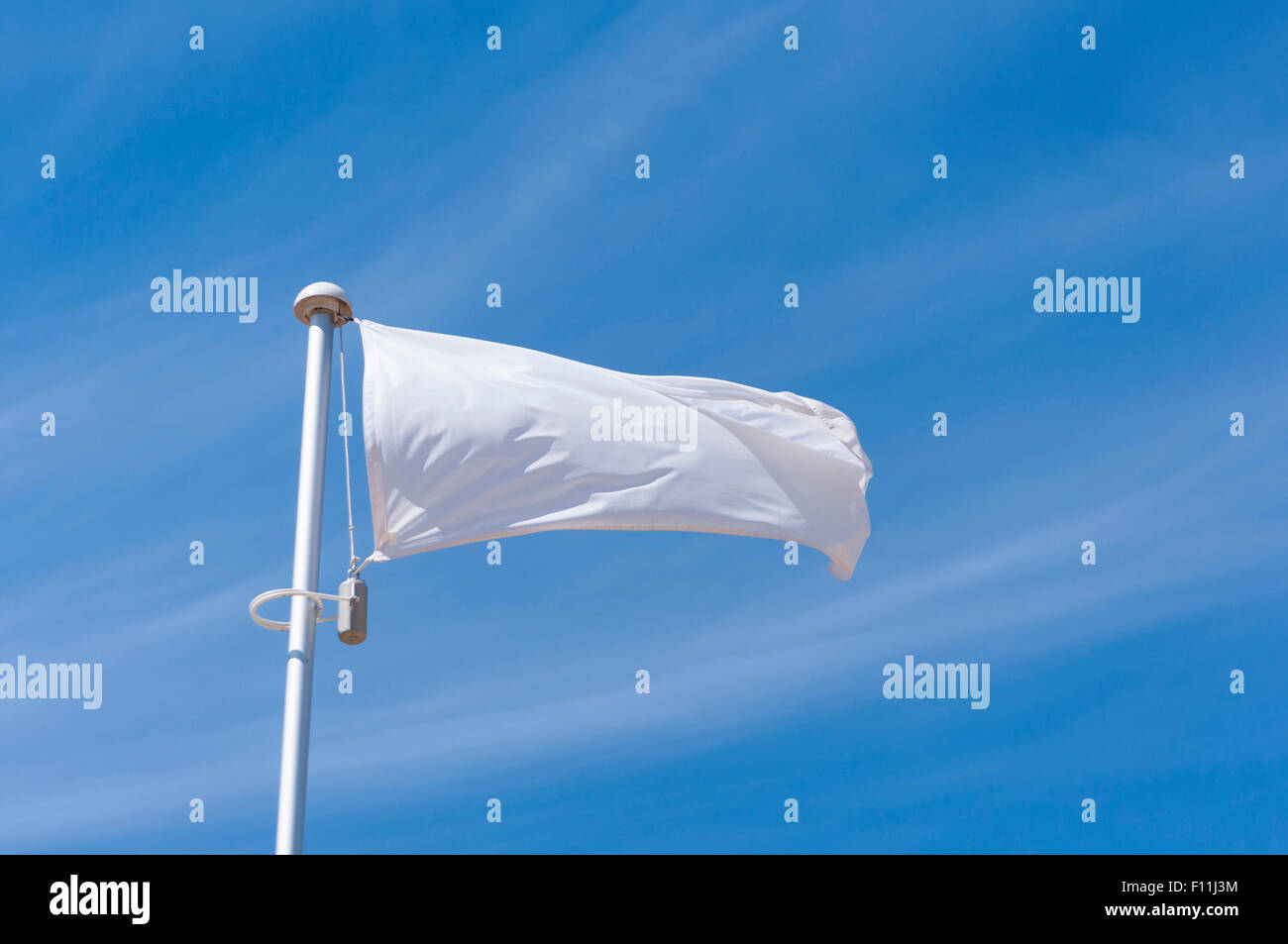Blank white flying flag on a blue sky Stock Photo - Alamy