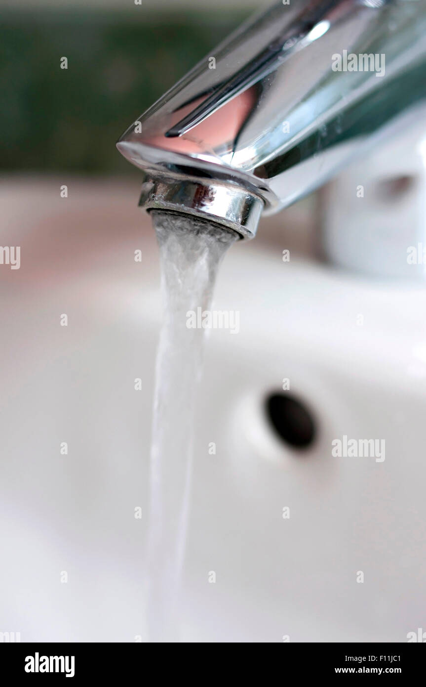 water tap with flowing water in modern bathroom Stock Photo - Alamy