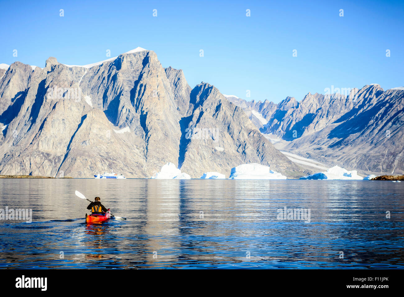 Woman paddling canoe towards glaciers in remote river Stock Photo - Alamy