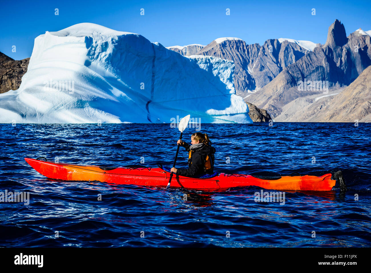 Woman paddling canoe near glaciers in remote river Stock Photo - Alamy