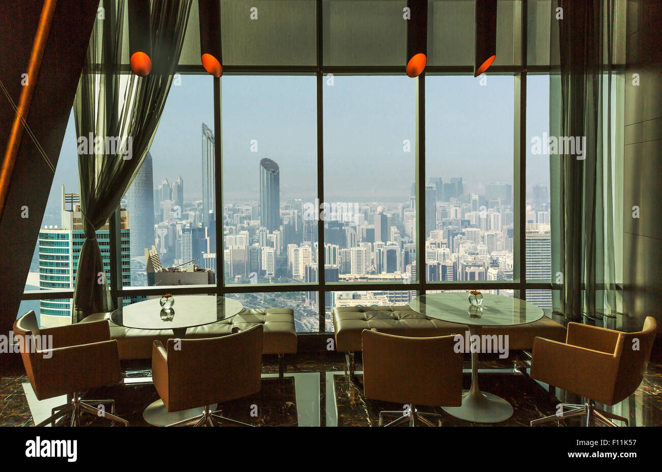 Restaurant tables overlooking Abu Dhabi cityscape, Abu Dhabi Emirate ...