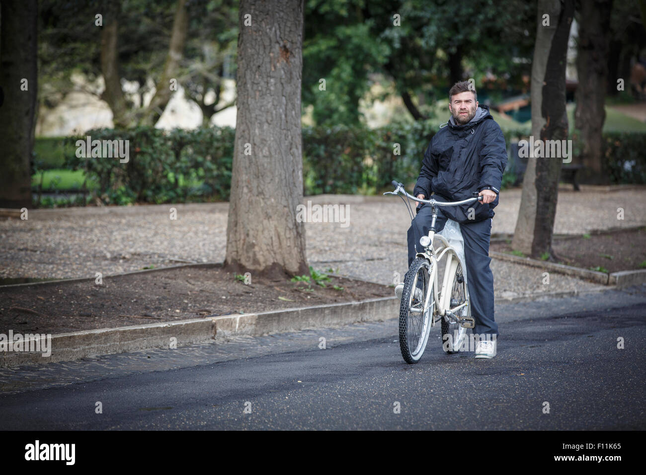 Caucasian man riding bicycle on street Stock Photo - Alamy