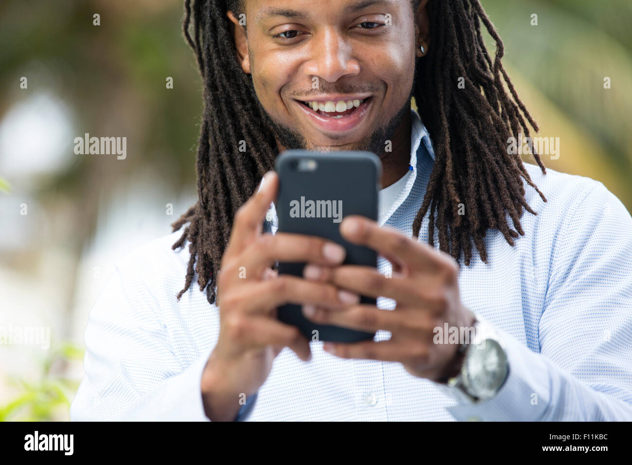 African American businessman using cell phone outdoors Stock Photo - Alamy