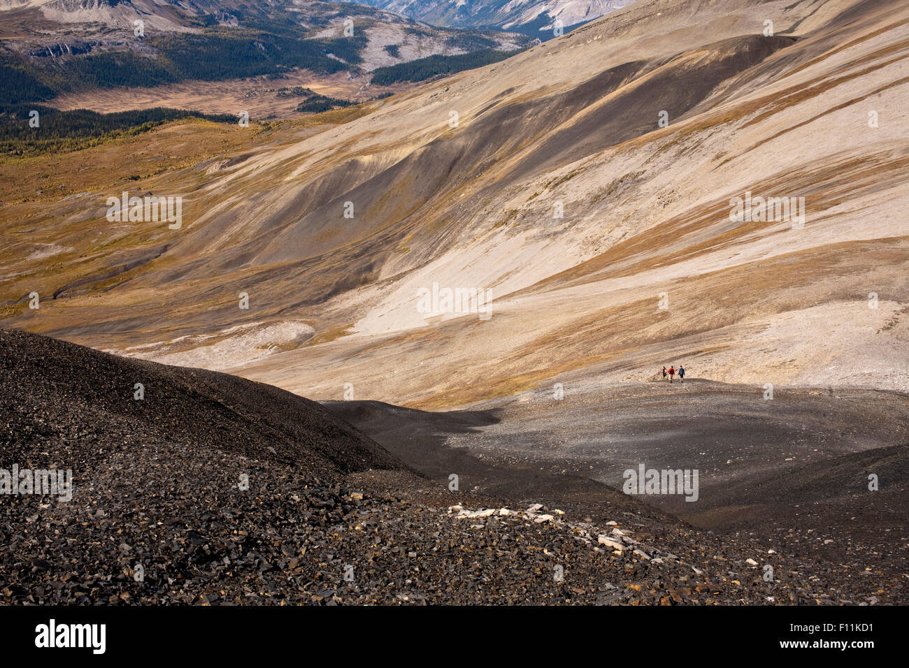 Distant view of hikers walking on remote hillside Stock Photo - Alamy