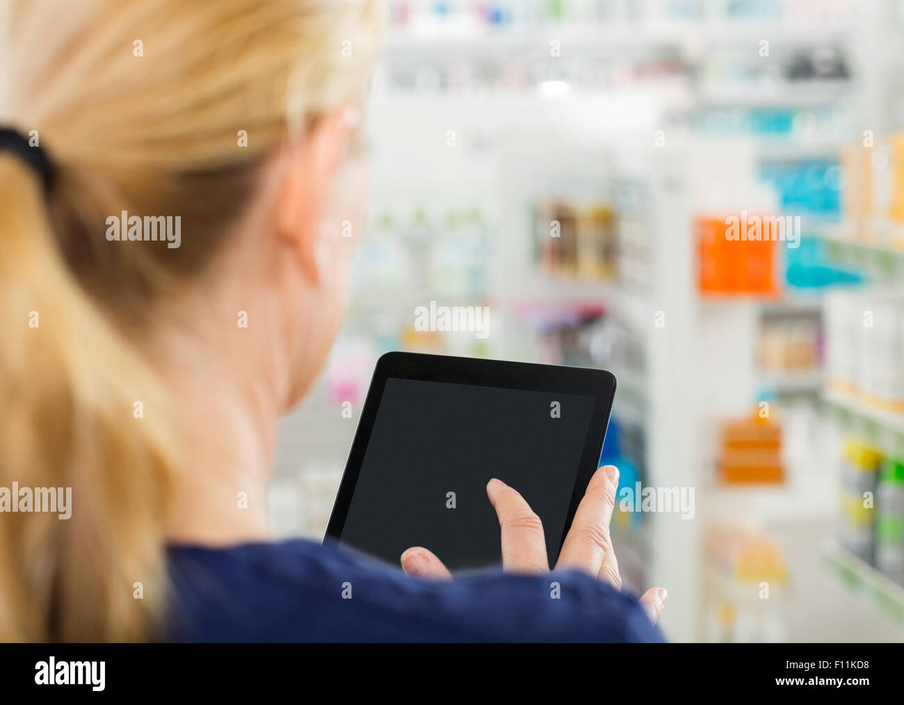 Pharmacist holding computer tablet using hi-res stock photography and ...