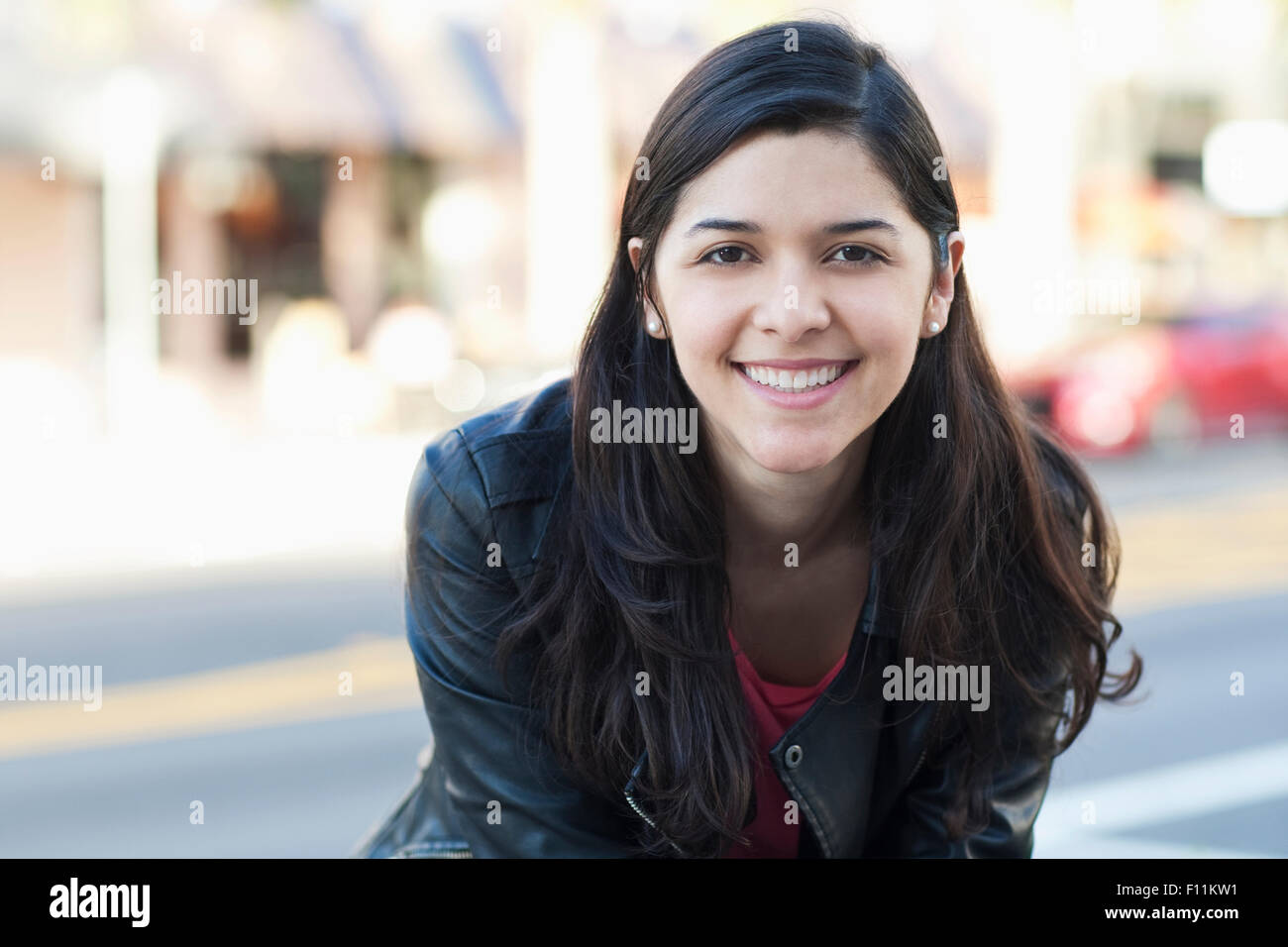 Hispanic woman smiling outdoors Stock Photo - Alamy