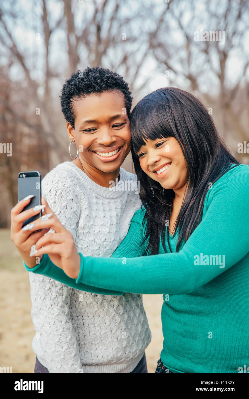 Black mother and daughter taking selfie outdoors Stock Photo - Alamy