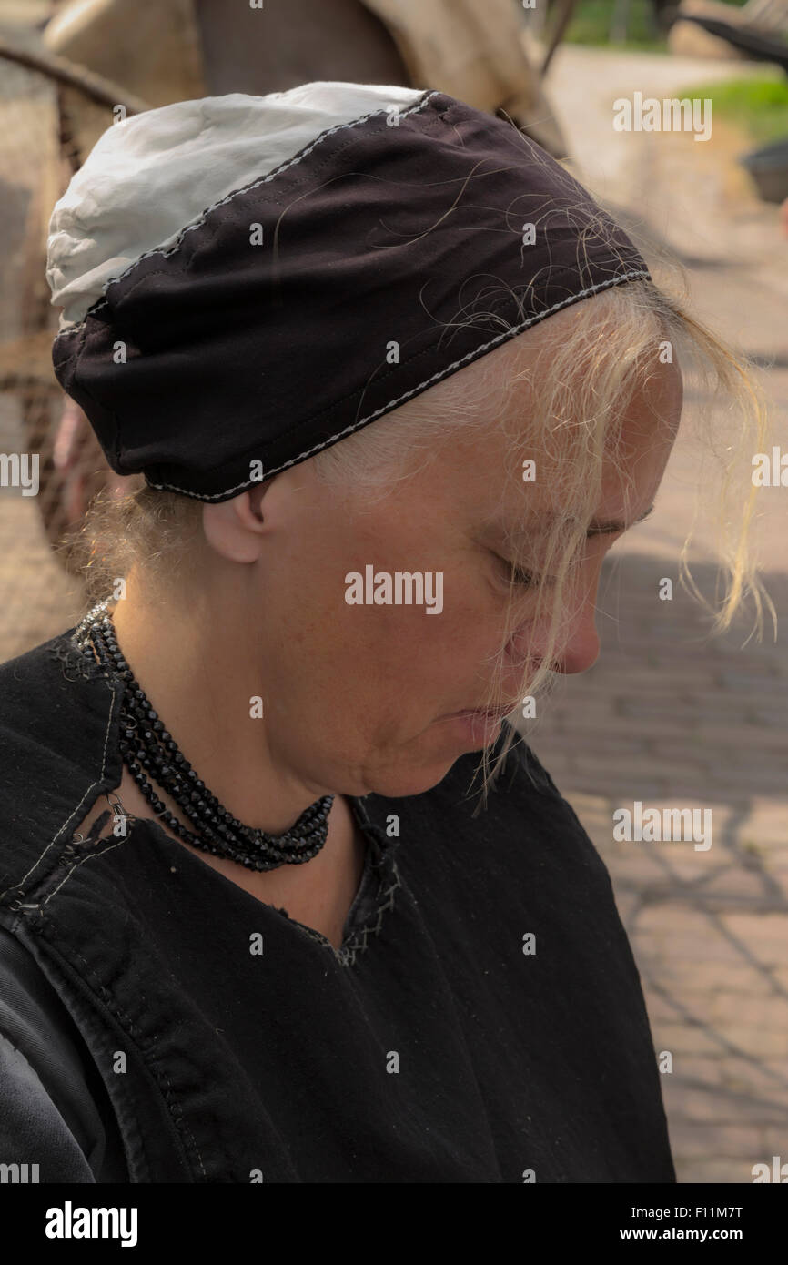 Portrait of woman in traditional dress, reenacting life from former ...