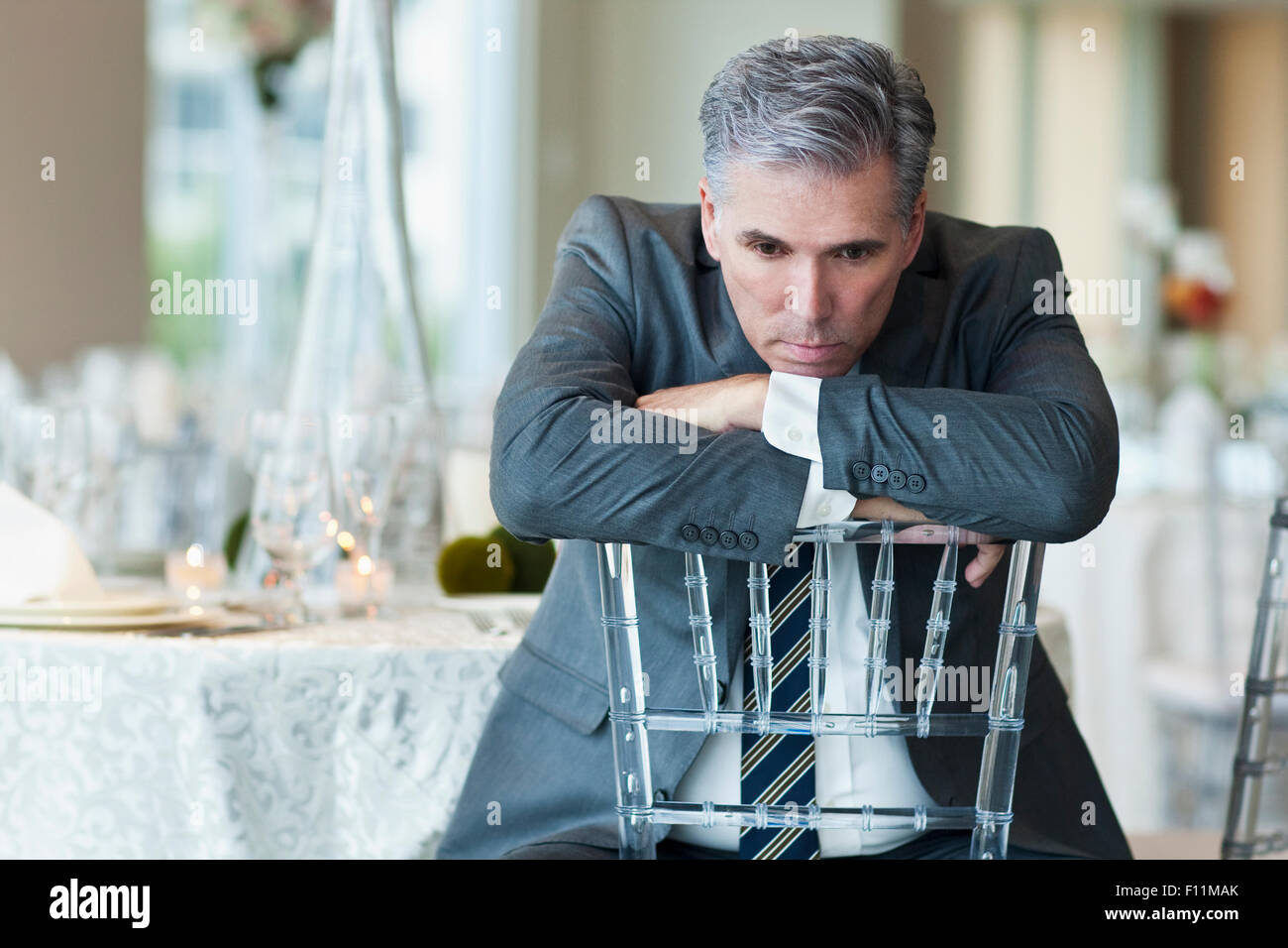 Caucasian businessman brooding in empty dining room Stock Photo - Alamy