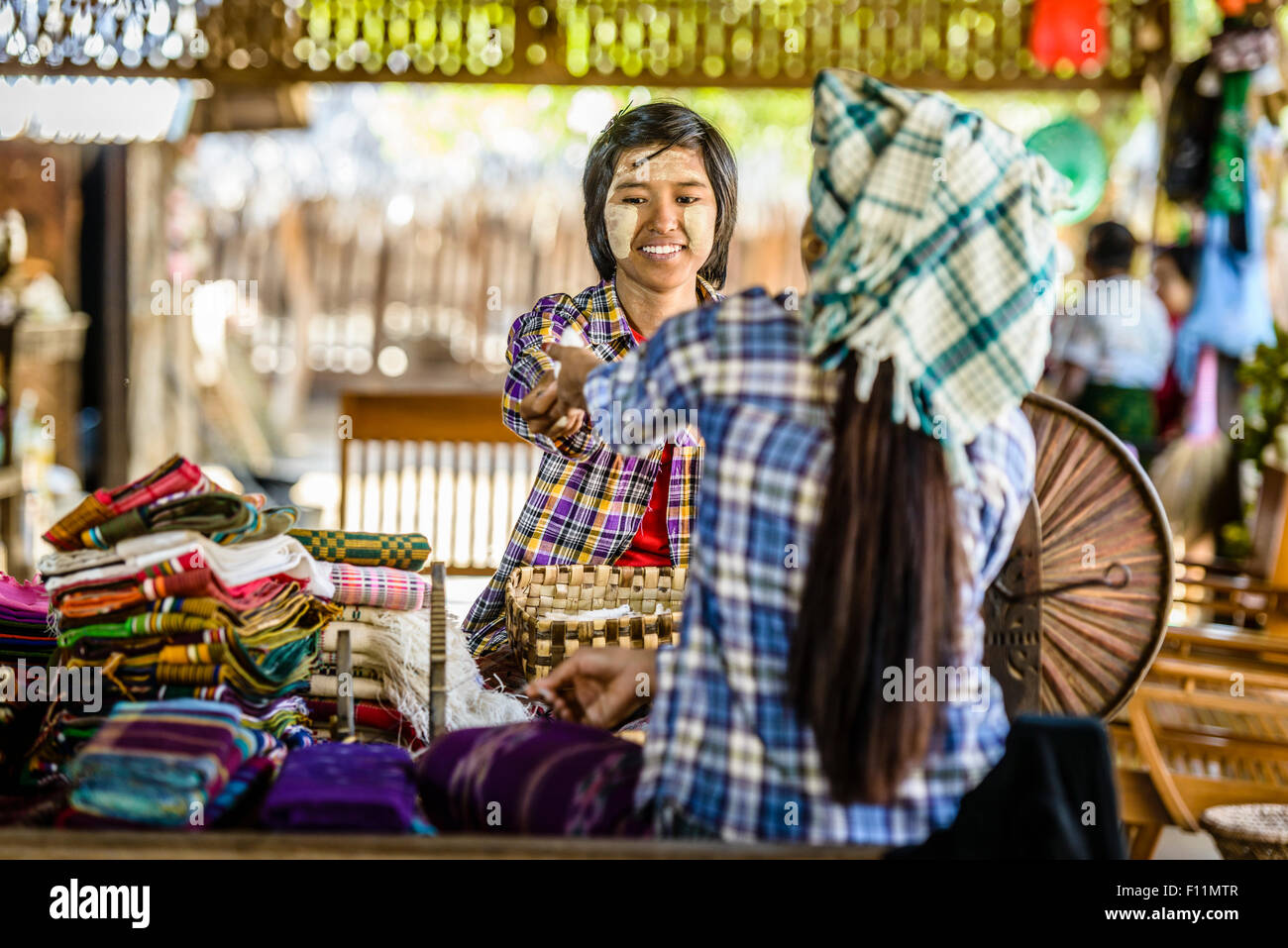 Asian teenage boy selling fabric at market Stock Photo - Alamy