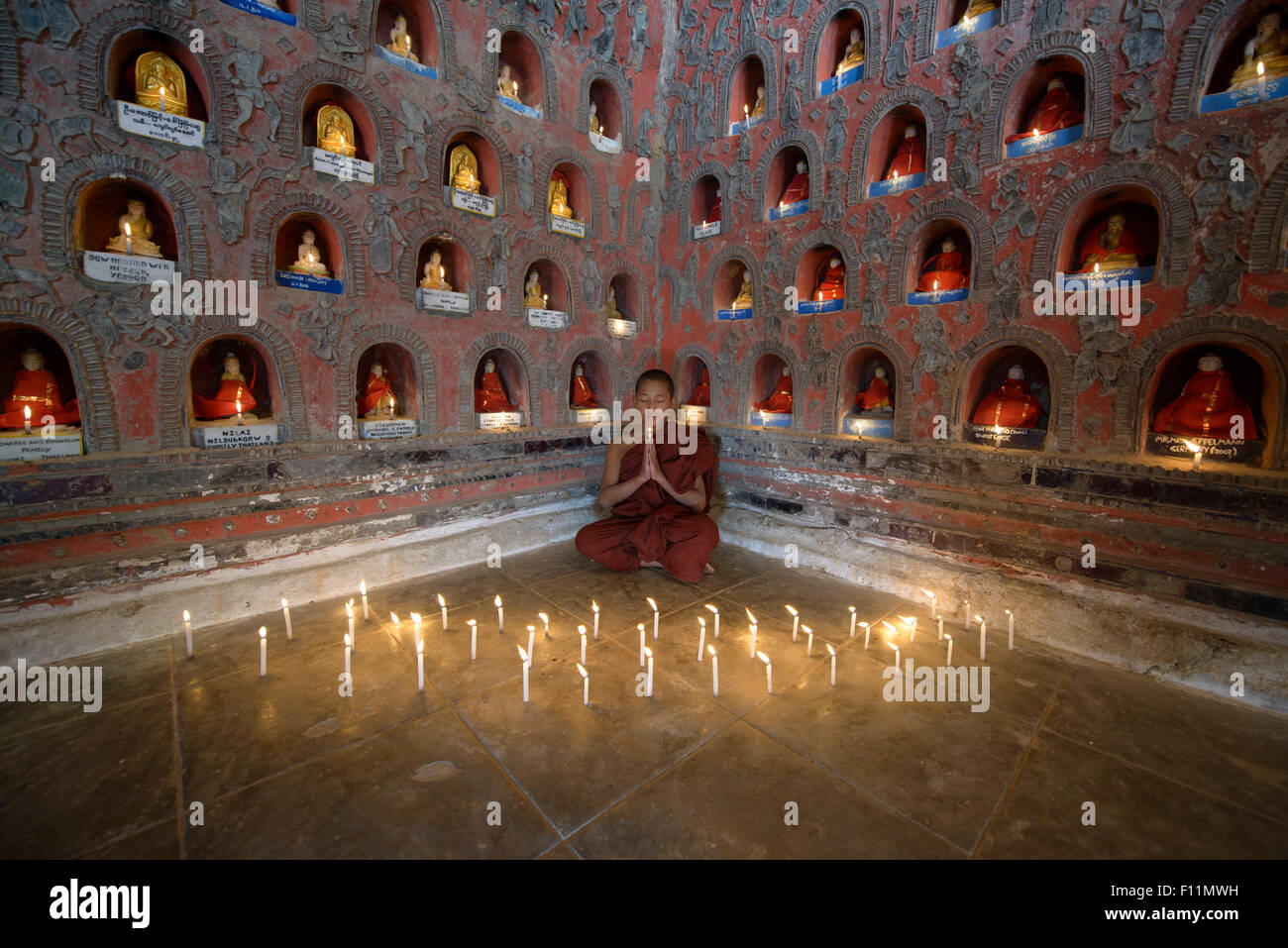 Asian monk-in-training praying in ancient temple Stock Photo - Alamy