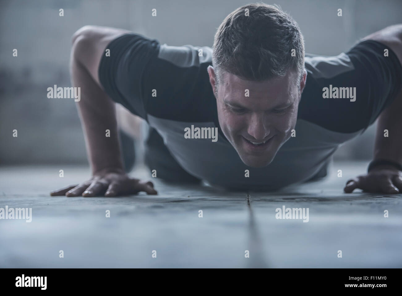 Caucasian athlete doing push-ups on floor Stock Photo - Alamy