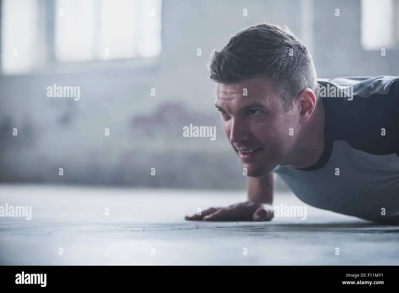 Caucasian athlete doing push-ups on floor Stock Photo - Alamy
