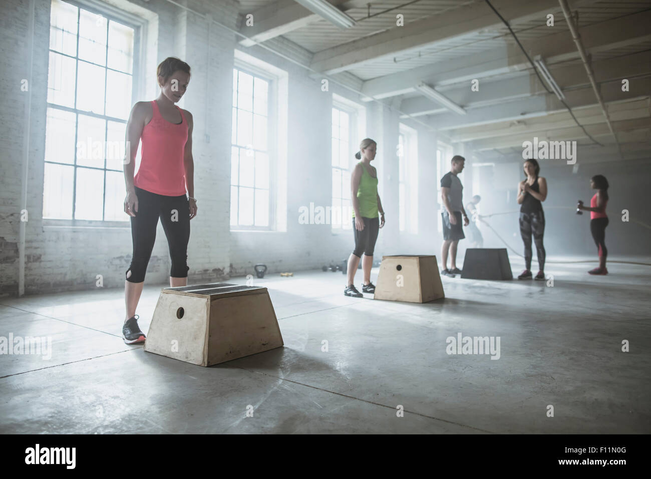 Athletes standing at platforms in gym Stock Photo - Alamy
