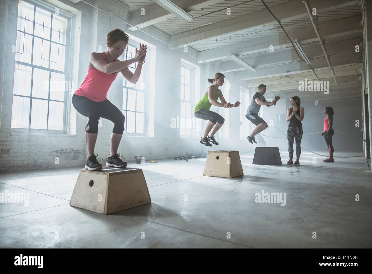 Athletes jumping on platforms in gym hi-res stock photography and ...