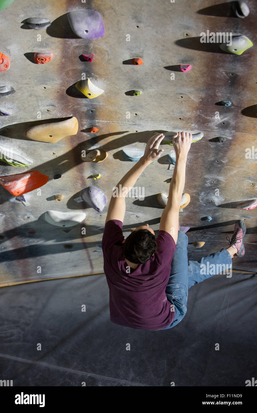 High angle view of athlete climbing rock wall in gym Stock Photo - Alamy