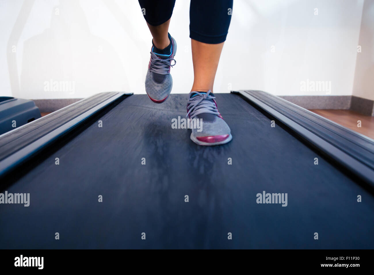 Closeup portrait of a female legs running on treadmill Stock Photo - Alamy