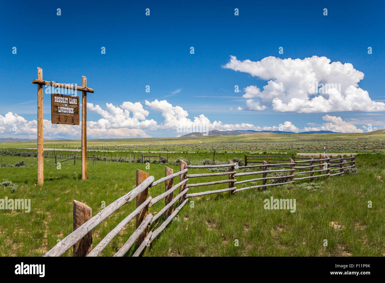 A roadway and ranch sign with storm clouds forming in rural Utah, USA ...