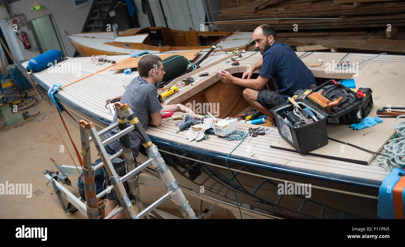 Flensburg, Germany. 12th Aug, 2015. Two men work on a sailing yacht at ...