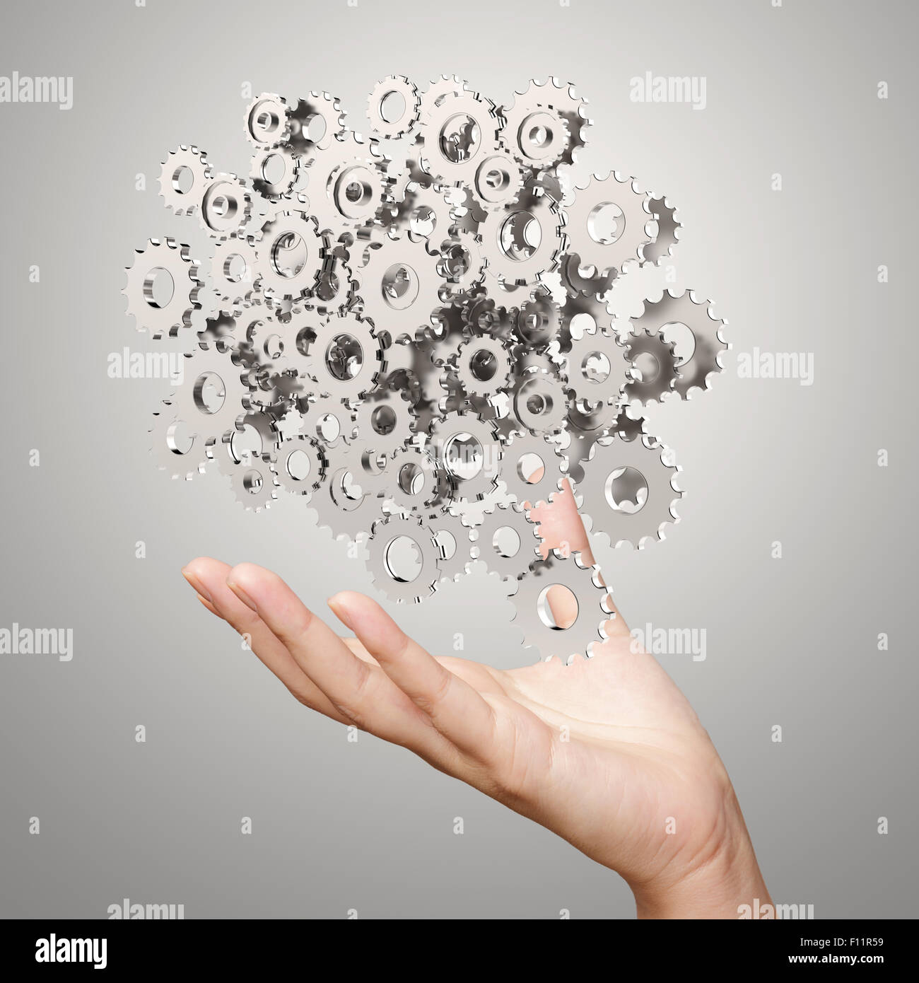 businessman hand showing gears cogs to success concept Stock Photo - Alamy