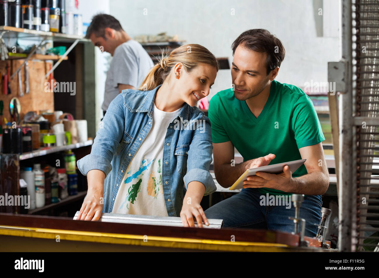 Supervisor Showing Design On Digital Tablet To Employee Using Sq Stock ...