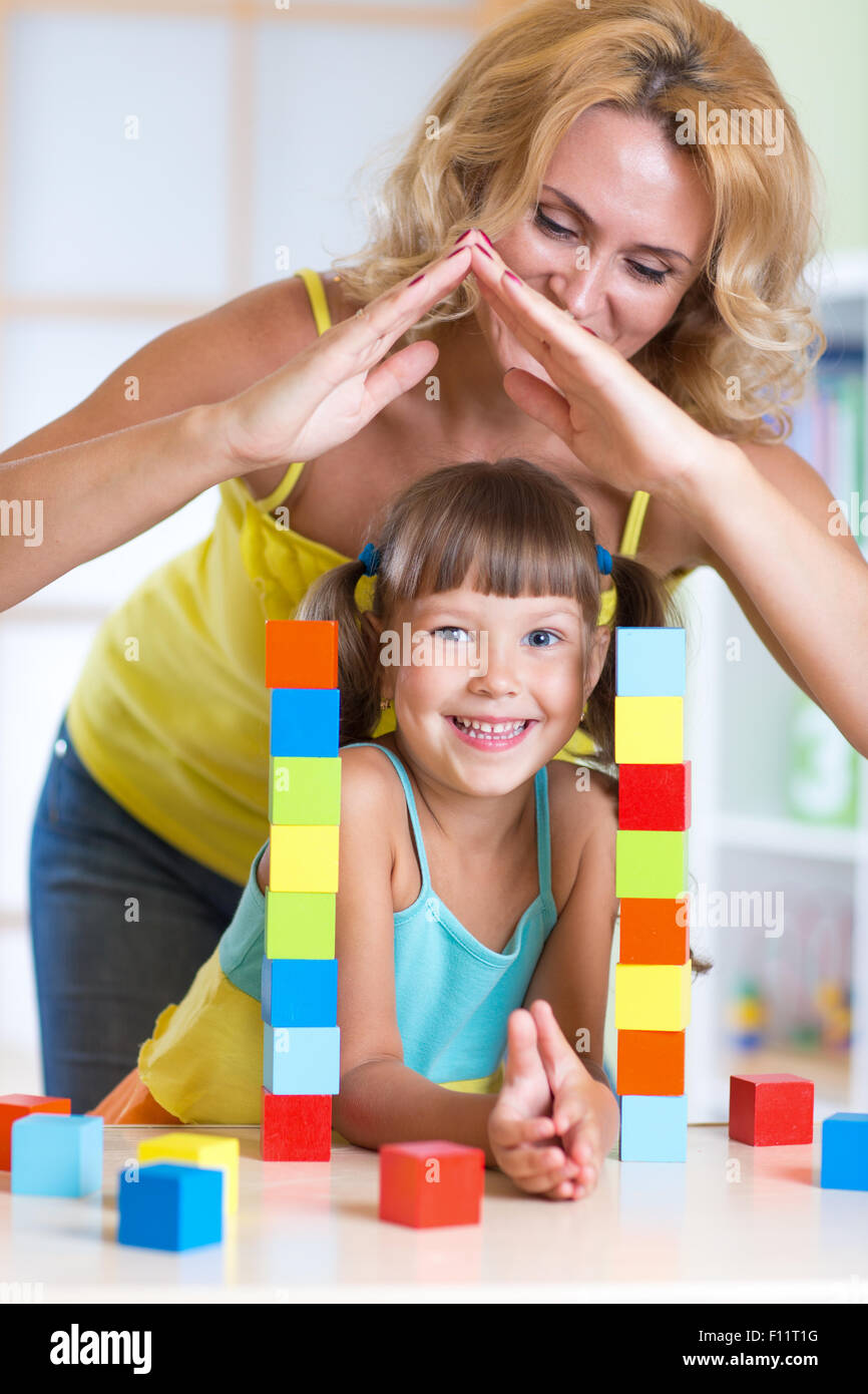 Mother forming house roof shape above child Stock Photo - Alamy