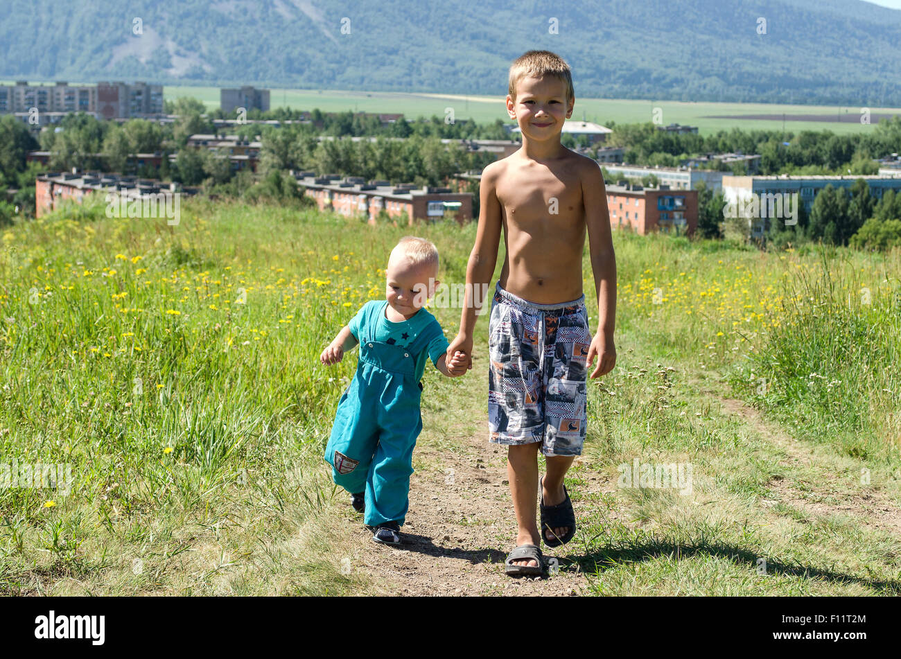 two brothers follow arms Stock Photo - Alamy