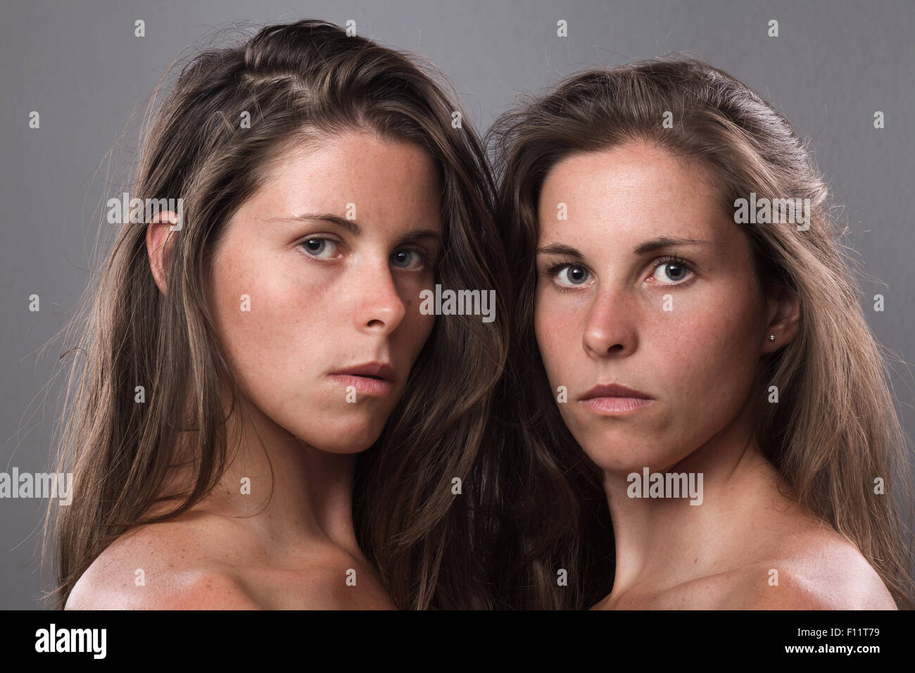 Two Serious Twin Sisters Looking at Camera Stock Photo - Alamy