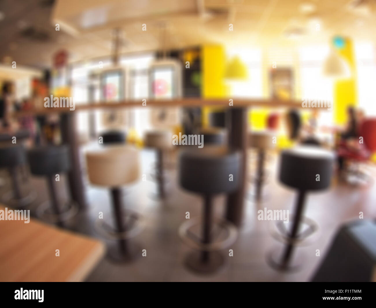 Defocused and blurry image of the interior of a fast food restaurant ...