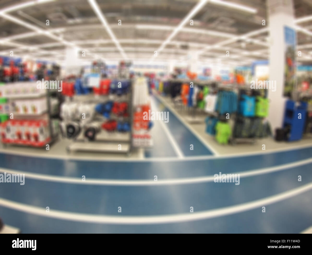 Defocused and blurry image of the interior of a clothing store with ...