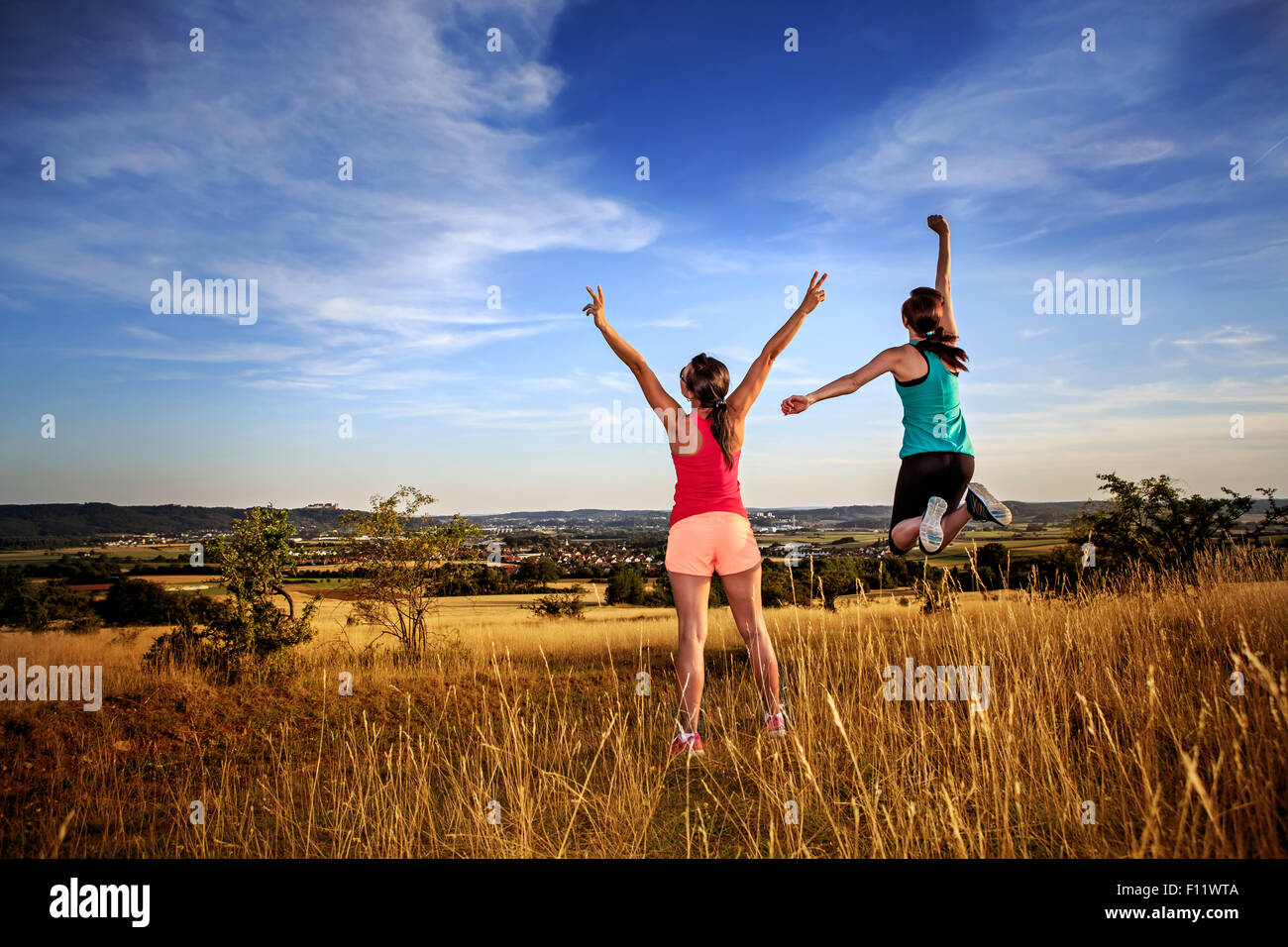 young women jogging in front of rural landscape Stock Photo - Alamy