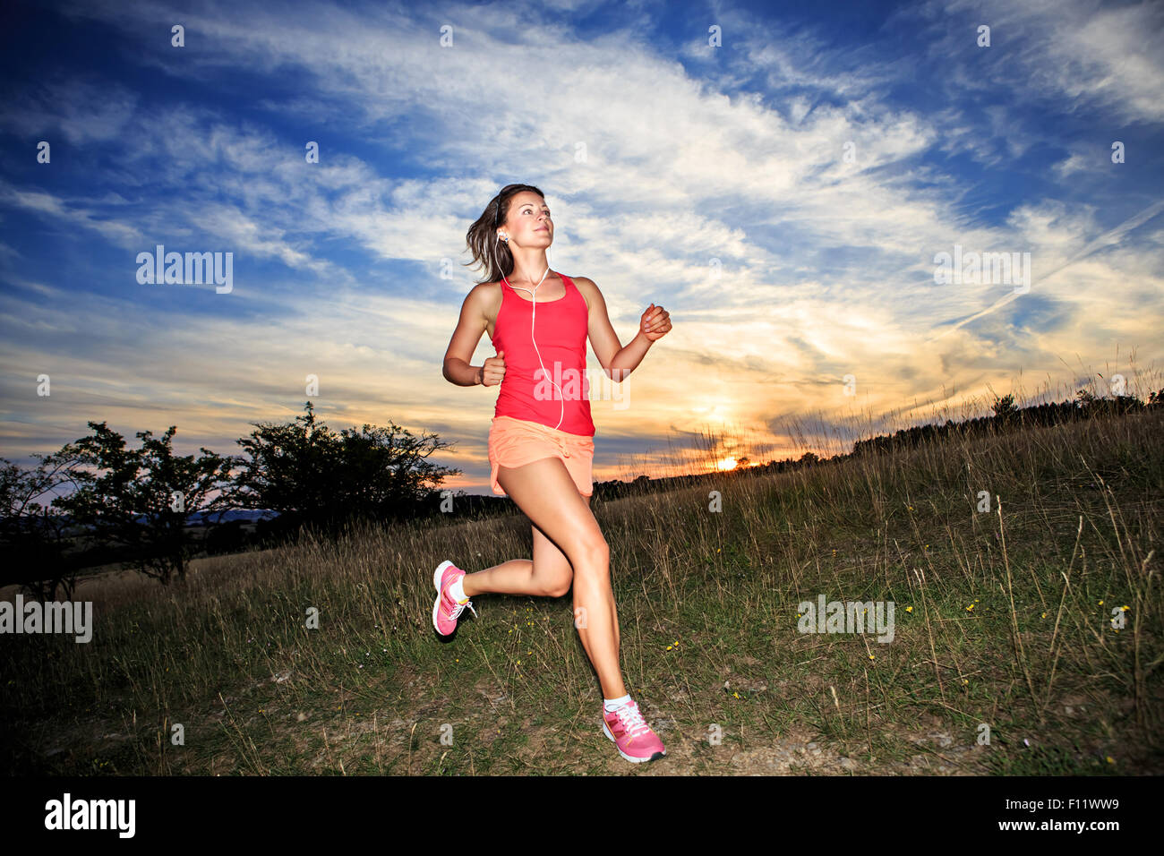 young woman jogging in front of rural landscape Stock Photo - Alamy