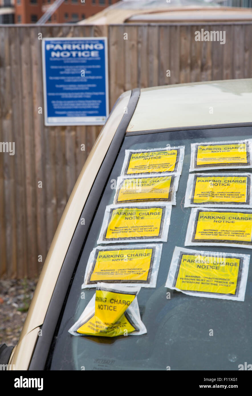 Parked car with multiple Parking Charge Notice stickers on the ...